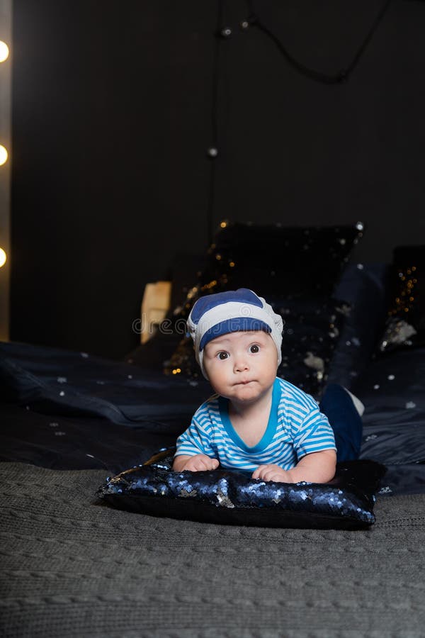 Beautiful Little Boy on the Bed in a Cozy Setting. Stock Photo - Image ...