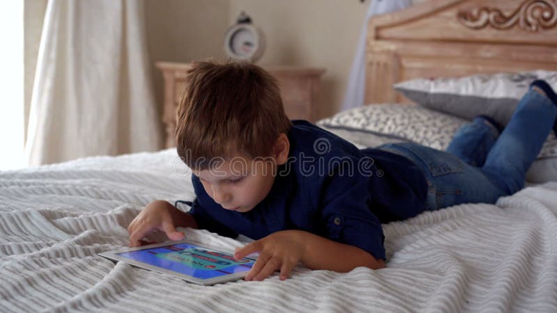 Beautiful Little Boy Playing on the Tablet Computer Games Stock Video ...