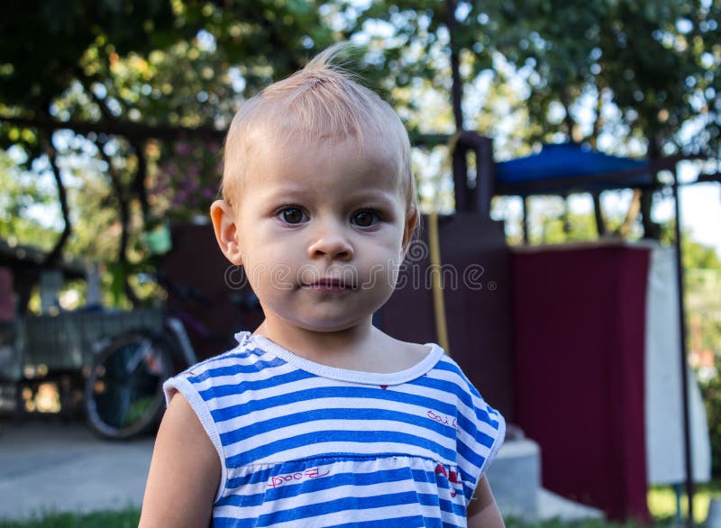 A Beautiful Little Child in the Backyard Stock Photo - Image of grass ...