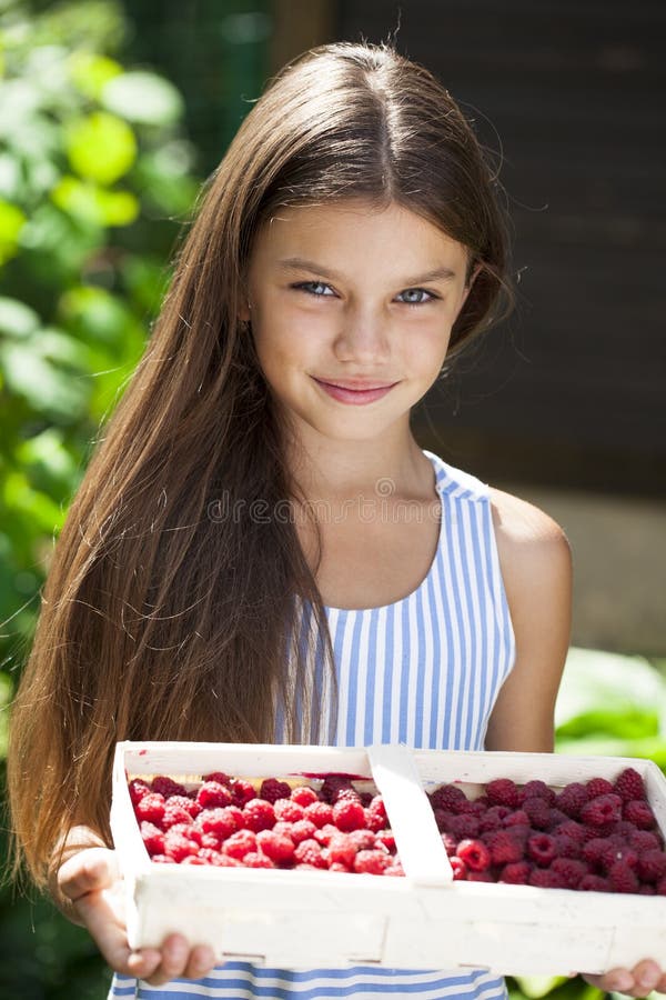 Beautiful Little Girl Holding a Box with a Raspberry Stock Image ...