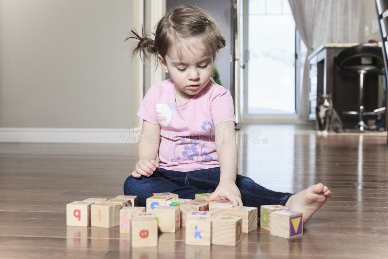 Beautiful Little Girl Playing with Blocks on Floor Stock Photo - Image ...