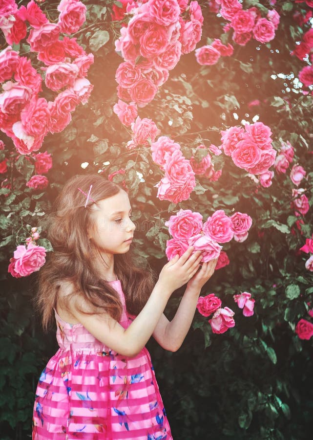 Beautiful Little Girl with Roses Outdoors. Stock Photo - Image of ...