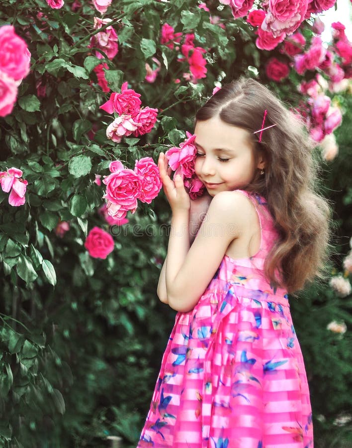 Beautiful Little Girl with Roses Outdoors. Stock Image - Image of ...