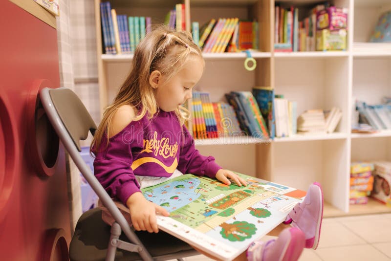 Beautiful Little Girl Read Interactive Book in Toy Store Stock Photo ...