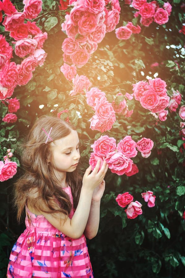 Beautiful Little Girl with Roses Outdoors. Stock Photo - Image of hair ...