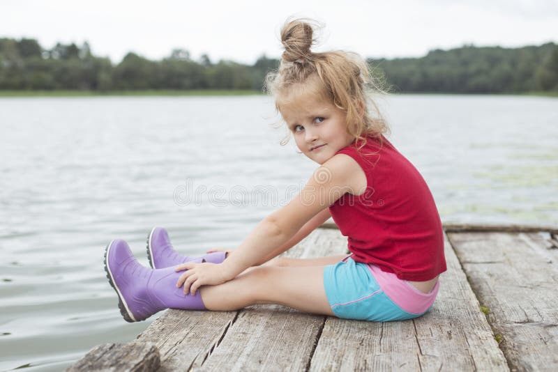 Beautiful Little Girl Sitting on the Bridge Stock Image - Image of ...
