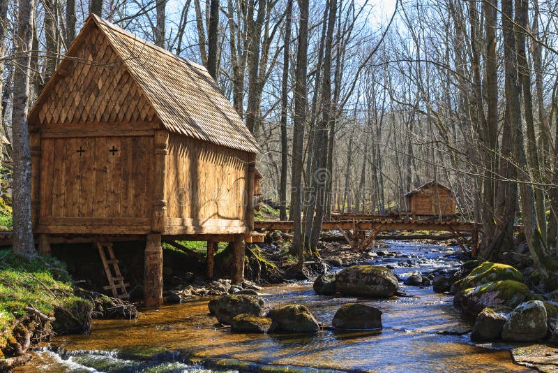 Beautiful Log Cabins by a Stream in the Forest and Footbridge Over the ...