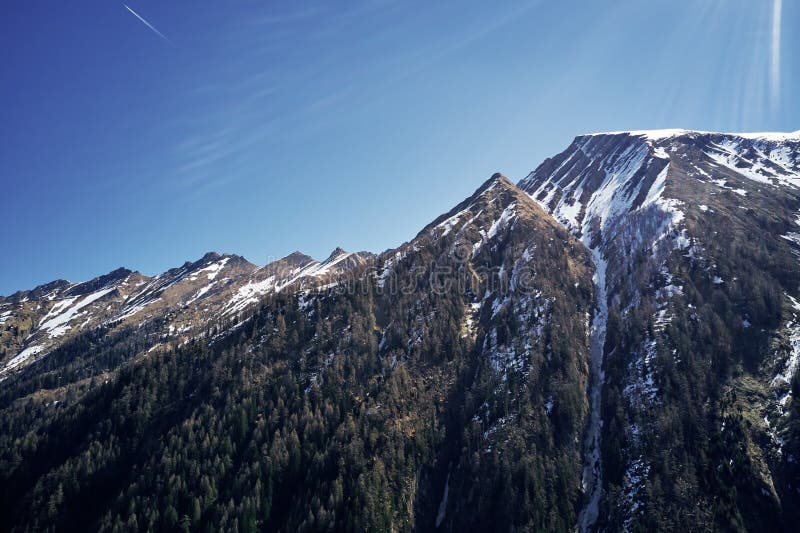 Beautiful Low Angle Shot of a Mountain with Snow Covering the Peak and ...