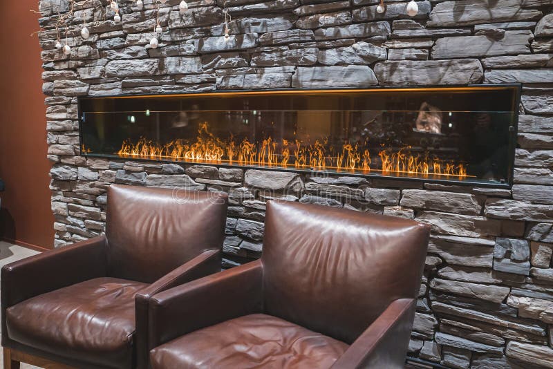 Beautiful Luxury Interior Design with a Long Fireplace and Sofas. Stock ...