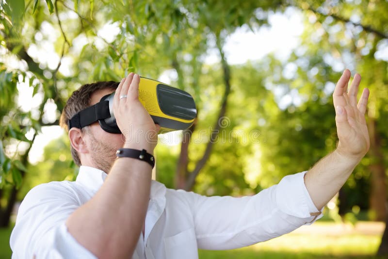 Mature Man Using Virtual Reality Headset Outdoor. VR, VR Glasses ...