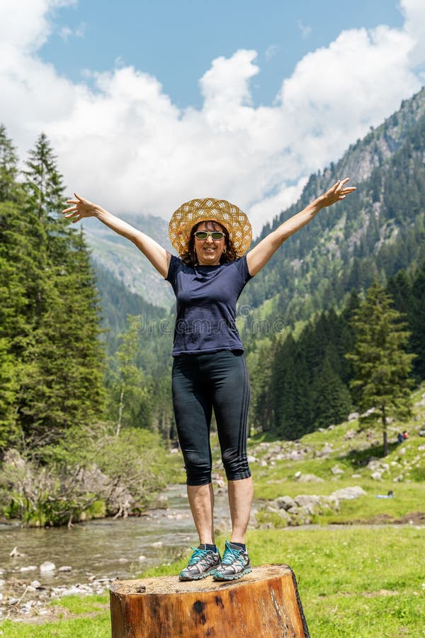 Beautiful Middle-aged Woman Having Fun during a Walk in the Mountains ...