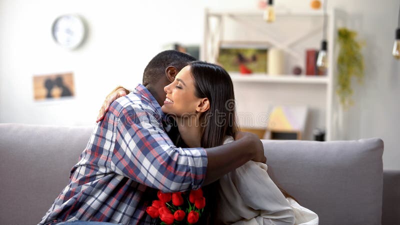 Beautiful Mixed Race Couple Hugging With Bouquet Of Tulips Loving