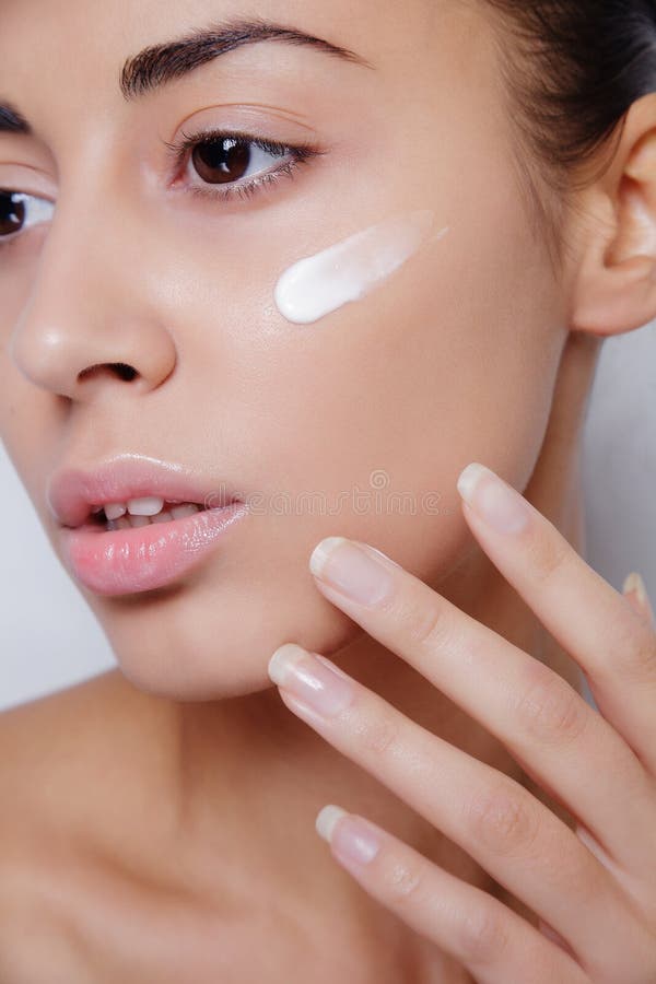 Beautiful Model Applying Cosmetic Cream Treatment On Her Face White