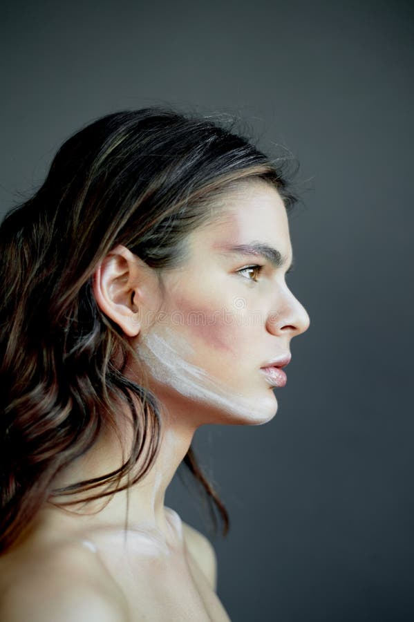 Beautiful Model. Stands in Profile, Makeup with Paint Strokes on the ...