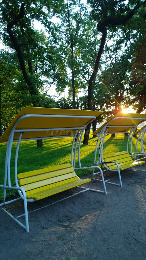 Beautiful Modern Bench-swing in a Public Park of the City at Sunset ...