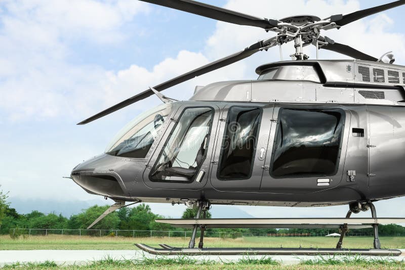 Beautiful Modern Helicopter on Helipad in Field Stock Image - Image of ...