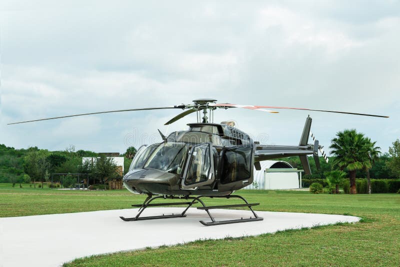 Beautiful Modern Helicopter on Helipad in Field Stock Image - Image of ...