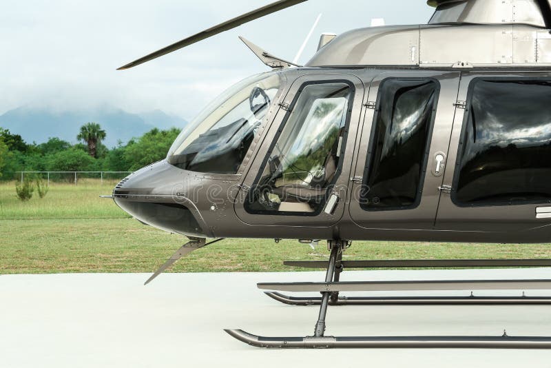 Beautiful Modern Helicopter on Helipad in Field Stock Image - Image of ...