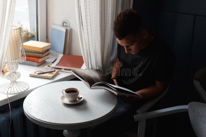 Beautiful Modern Man Rest in a Restaurant, Reading a Book Stock Image ...