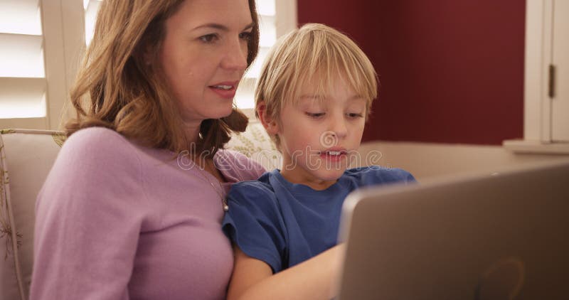 Beautiful Mother Teaching Her Young Boy on a Laptop Computer Stock ...