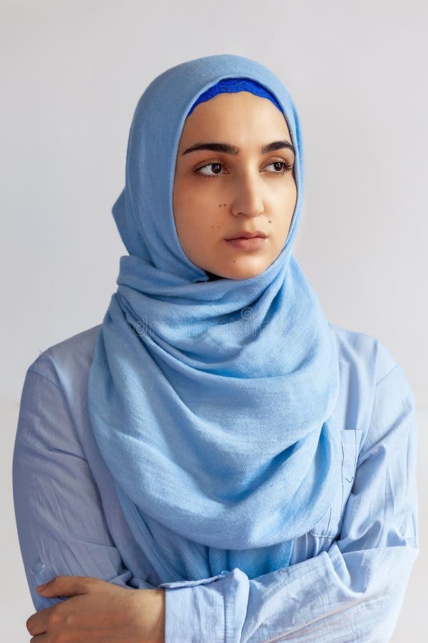 Beautiful Muslim Woman in Hijab Against White Background. Portrait of ... Beautiful Muslim Woman in Hijab Against White Background. Portrait of ...