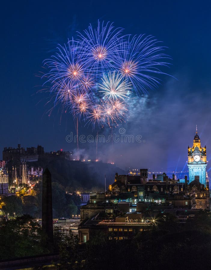 Beautiful Night View of City Lights and a Colorful Firework in the ...