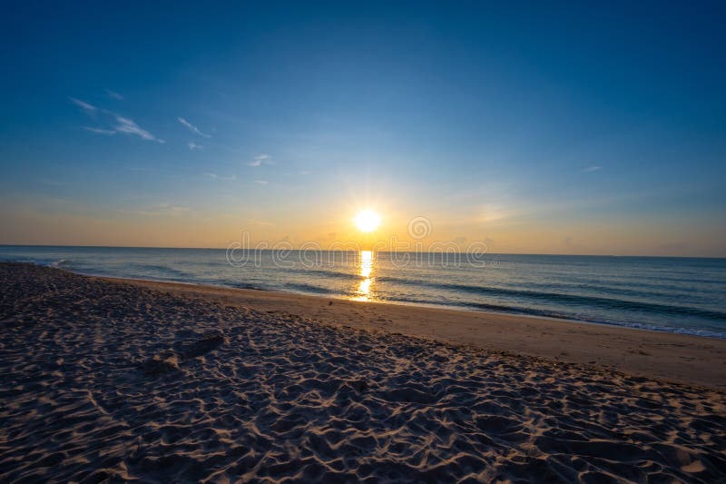 Beautiful Ocean Beach Sunrise with Deep Blue Sky and Sun Rays Stock ...