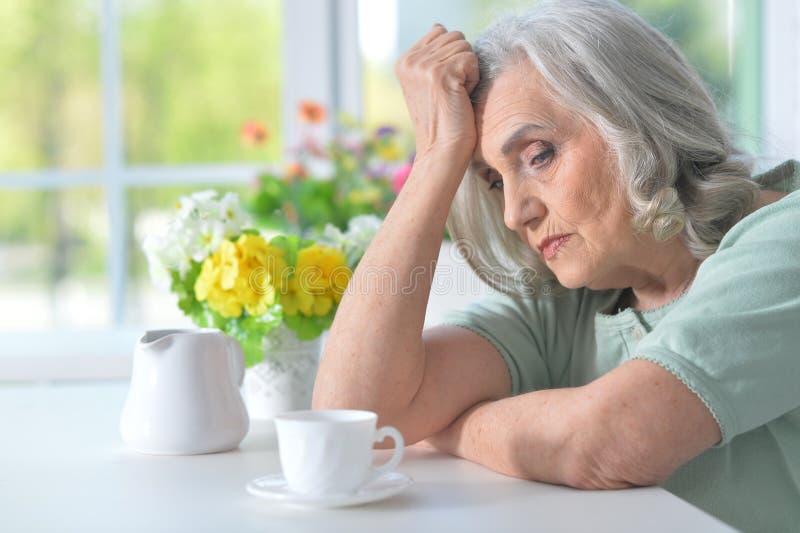 Beautiful old woman is sad stock image. Image of sunset - 93678165