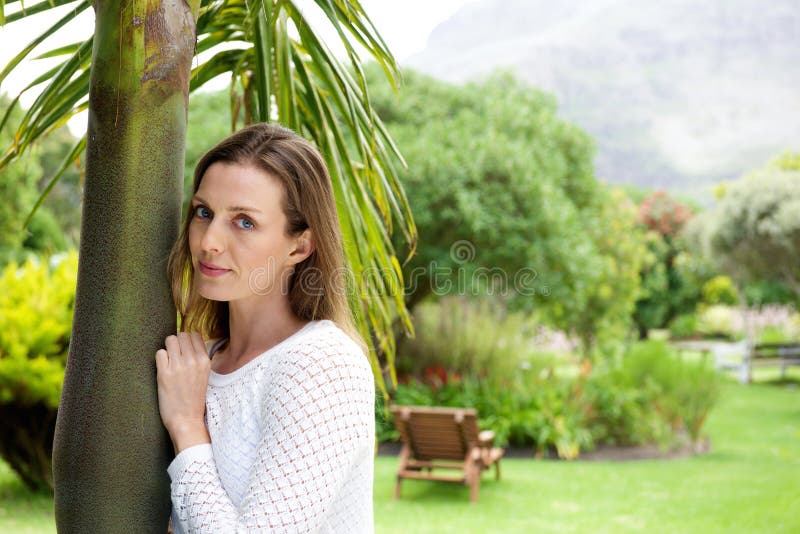 Beautiful Older Woman Leaning Against Tree Stock Photo - Image of ...