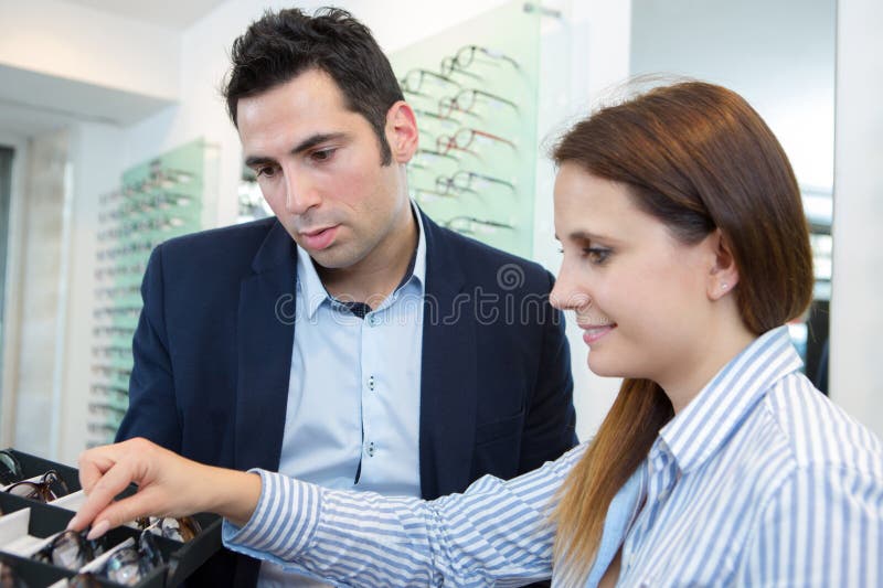 Beautiful Ophthalmologist Helping Male Patient Stock Photo - Image of ...