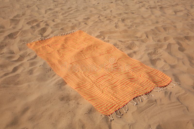 Beautiful Orange Striped Beach Towel on Sand Stock Photo - Image of ...