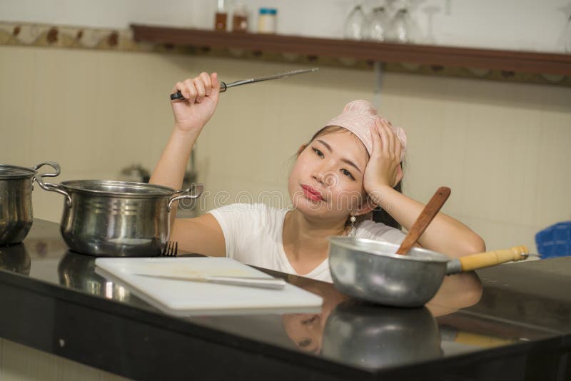 Beautiful Overwhelmed And Stressed Chinese Girl Working In Kitchen