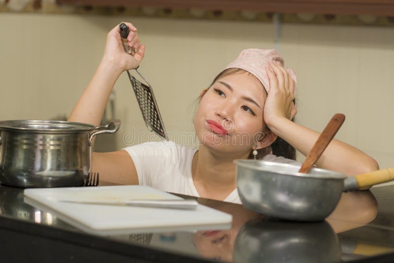 Beautiful Overwhelmed And Stressed Chinese Girl Working In Kitchen