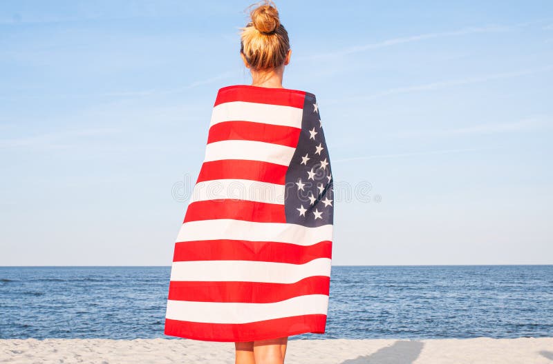 Beautiful Patriotic Woman With American Flag On The Beach Usa
