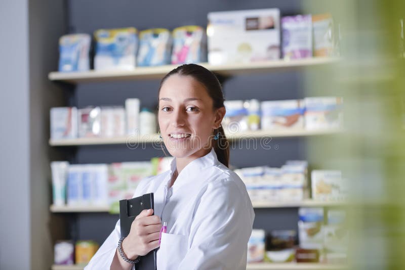 Beautiful Pharmacist Using Notepad at the Pharmacy Stock Image - Image ...