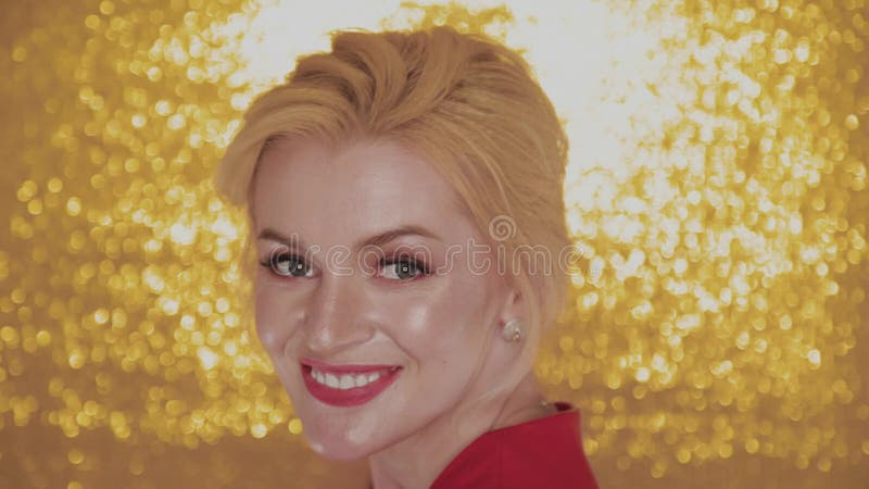 Beautiful Photo Model Posing on a Gold Background in a Photo Studio ...