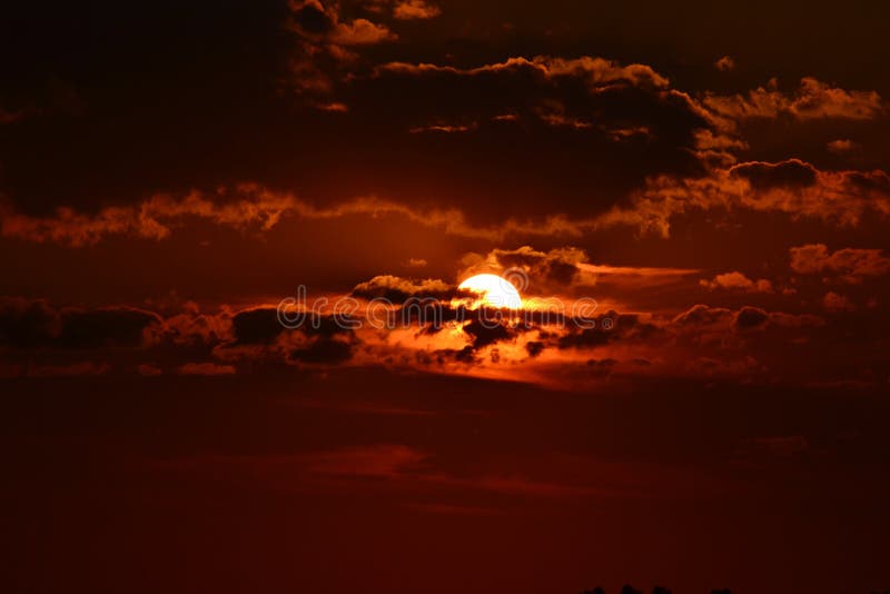 Beautiful Picture of a Mesmerizing Orange Sun in the Clouds Stock Photo ...