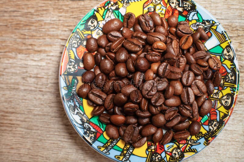 A Beautiful Plate of Coffee Beans Stands on the Old Wooden Table Stock ...