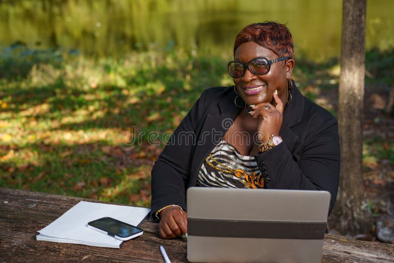 Beautiful Plus Sized Model Working Remotely from a Nature Scene Stock ...