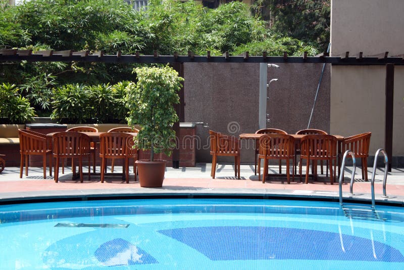 Beautiful Poolside Arrangement Stock Image - Image of blue, tables ...