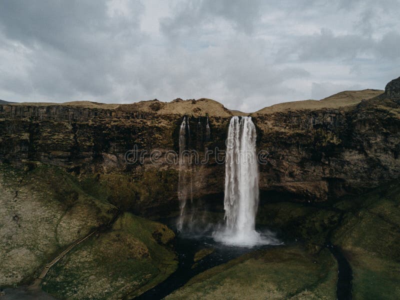 Beautiful Powerful Waterfall Flowing in a River Under a Cloudy Sky ...