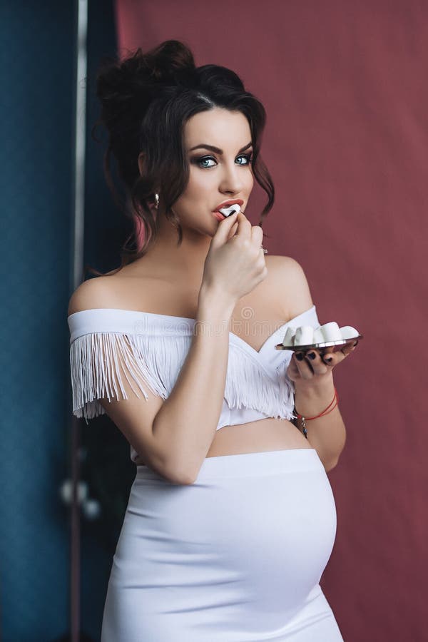 Beautiful Saucy Pregnant Model With Long Brown Hair In The White T