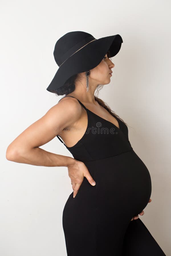 A Pregnant Woman In A Black Dress And Hat Stock Image Image Of