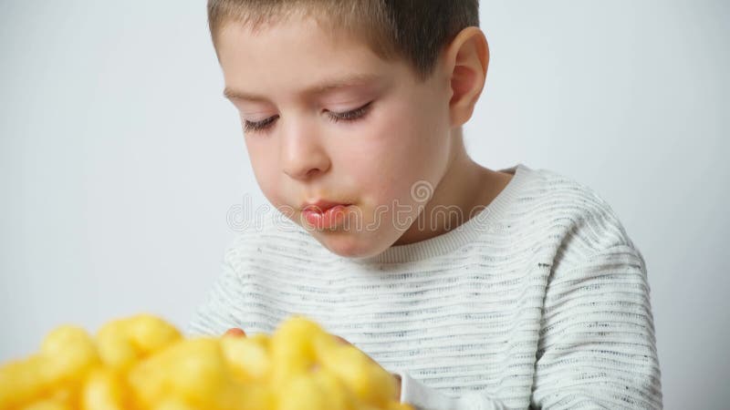 Beautiful Preschool Boy Eating Delicious Crispy Corn Chips on a White ...