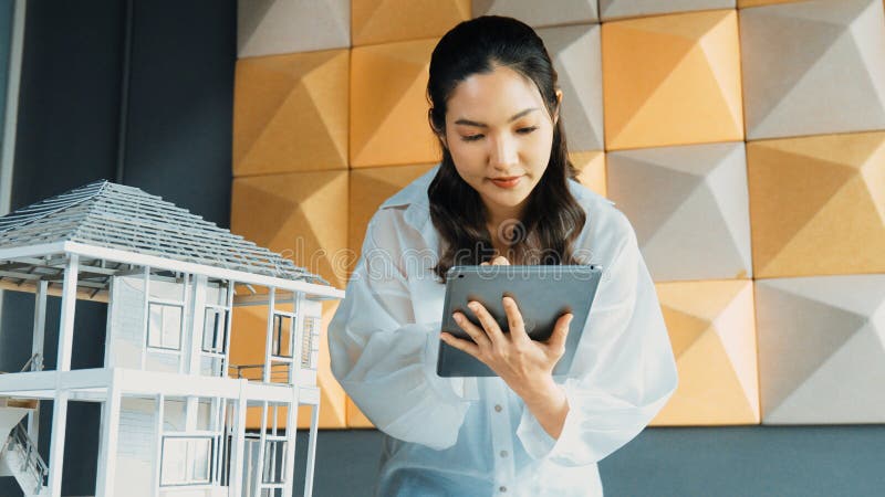 Beautiful Asian Project Manager Using Tablet Check House Model ...