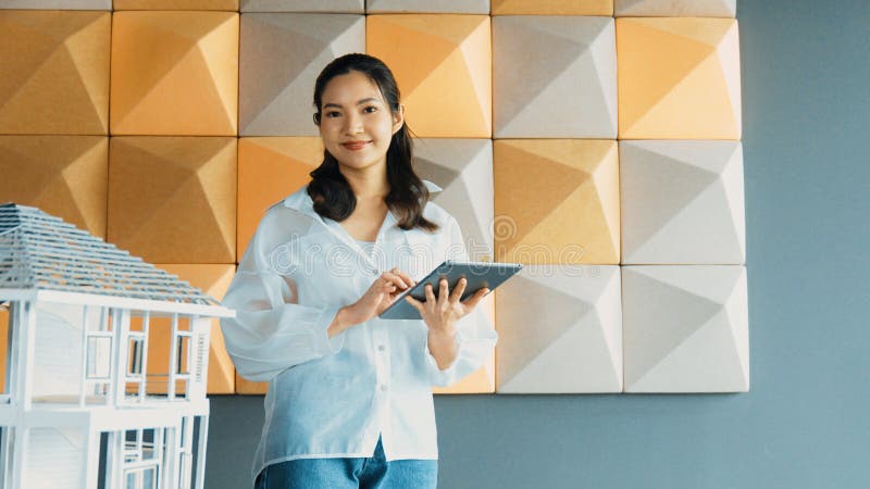 Beautiful Asian Project Manager Using Tablet Check House Model ...