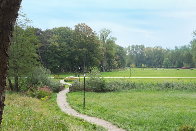Beautiful Public City Park with Pathway and Green Grass Stock Photo ...