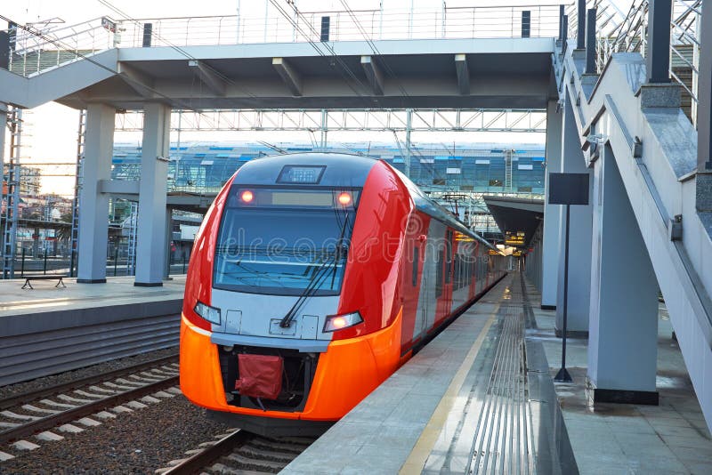 Beautiful Railway Station with Modern Red Commuter Train . Stock Photo ...