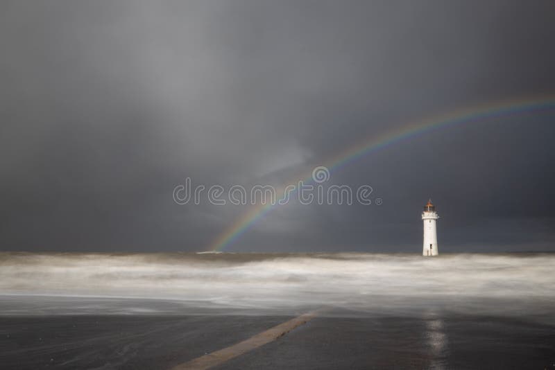 A Beautiful Rainbow Appears Over Lighthouse Stock Photo - Image of ...