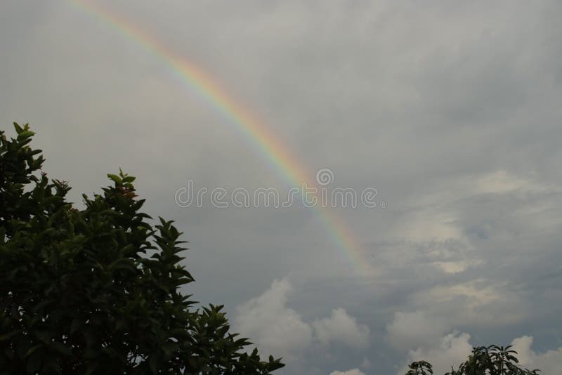 Rainbow View on a Cloudy Sky after Rain Over the Mountain Stock Image ...